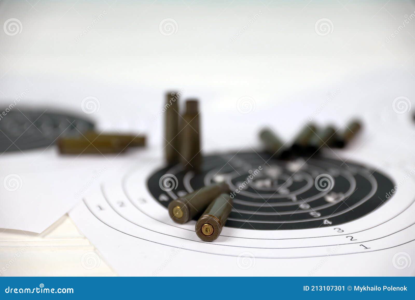 Gun And Many Bullets Shooting Targets On White Table In Shooting Range ...
