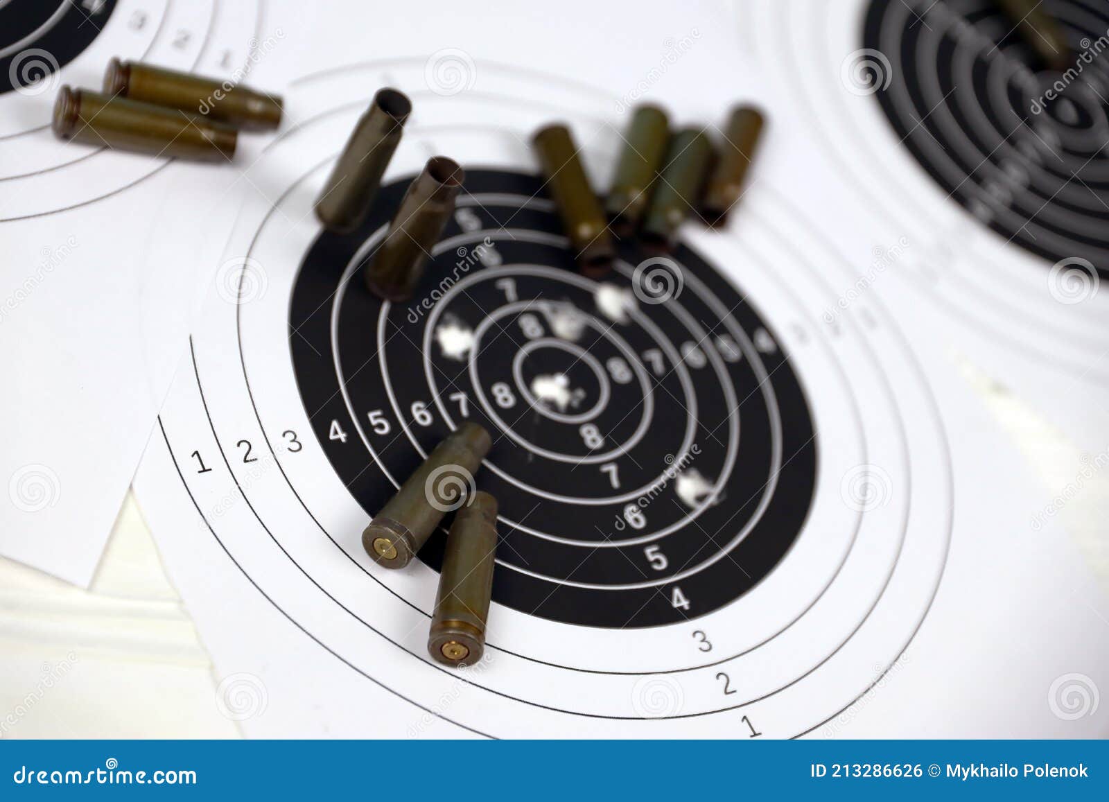 Many Bullets on Shooting Targets on White Table in Shooting Range ...
