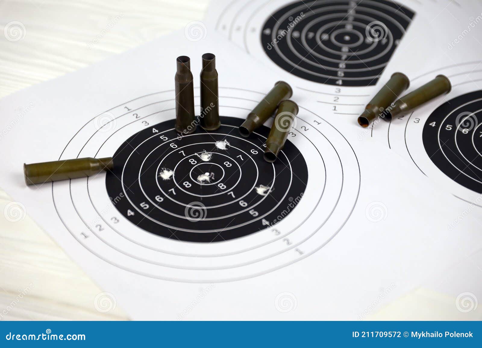 Many Bullets On Shooting Targets On White Table In Shooting Range ...