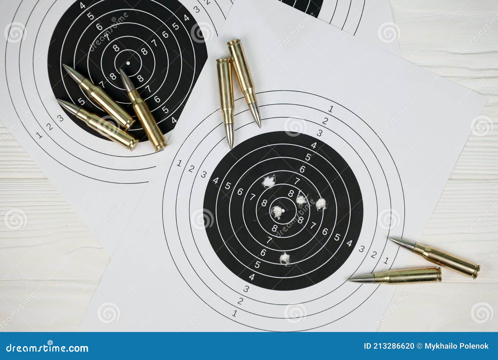 Many Bullets on Shooting Targets on White Table in Shooting Range ...