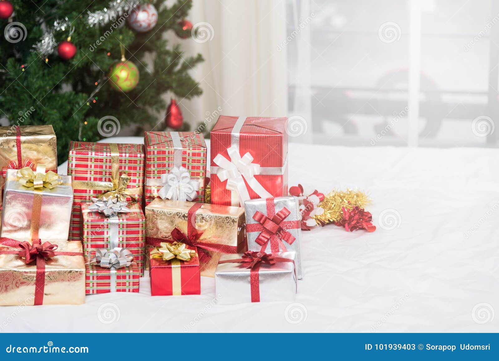 Many Christmas Presents Gift Boxes on a Table with Christmas Tree Stock ...