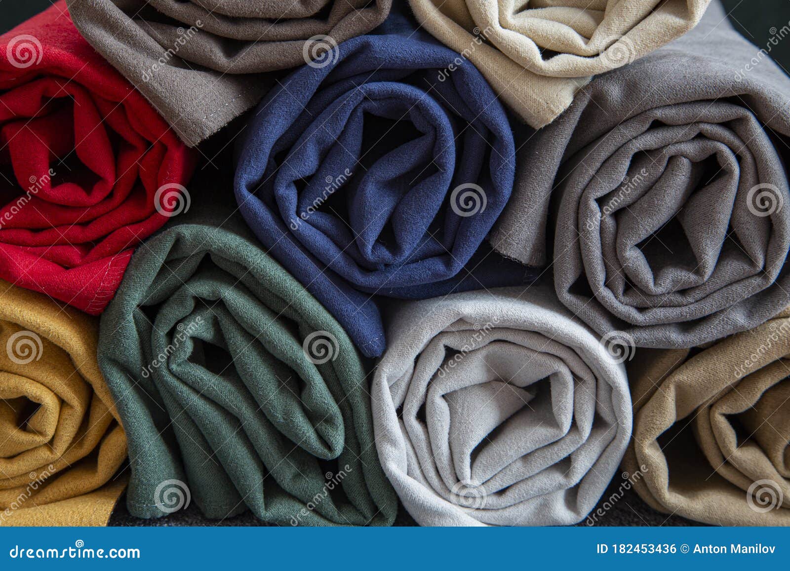 Many Colorful Rolls of Fabric on a Plain Background Stock Photo - Image ...