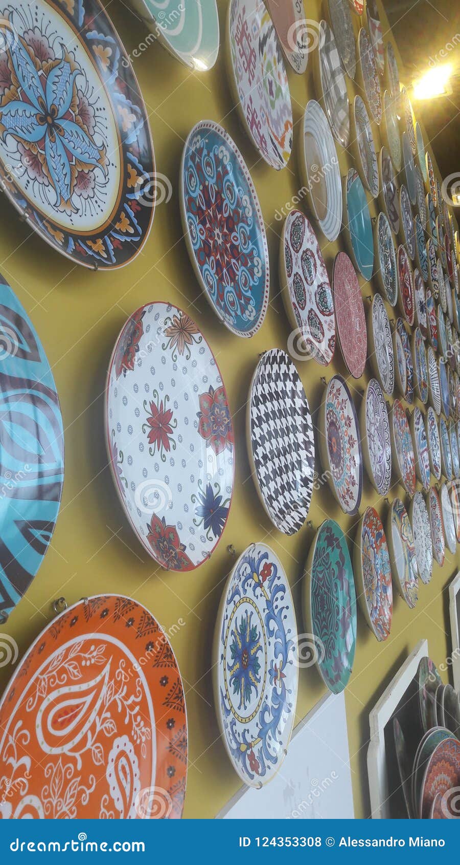 Coloured dishes on wall stock photo. Image of dishes - 124353308