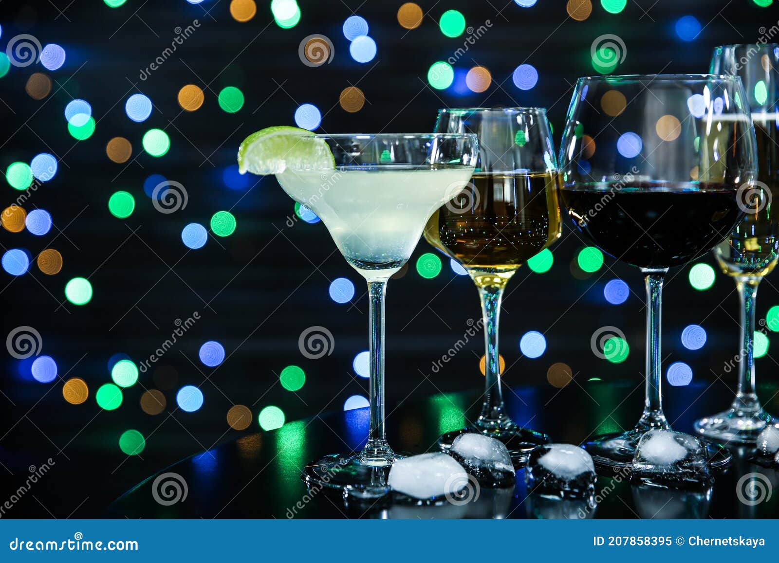 Many Different Alcoholic Drinks on Table Against Dark Background with ...