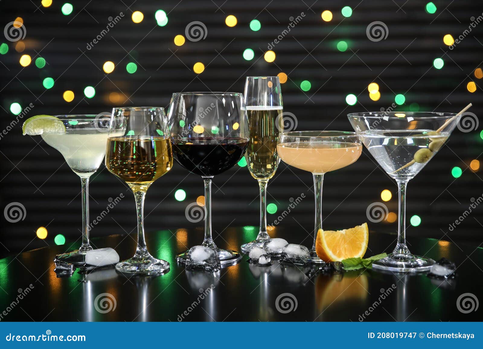 Many Different Alcoholic Drinks on Table Against Dark Background with ...