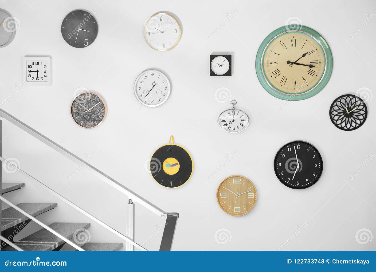 Many Different Clocks Hanging on White Wall. Stock Photo - Image of ...