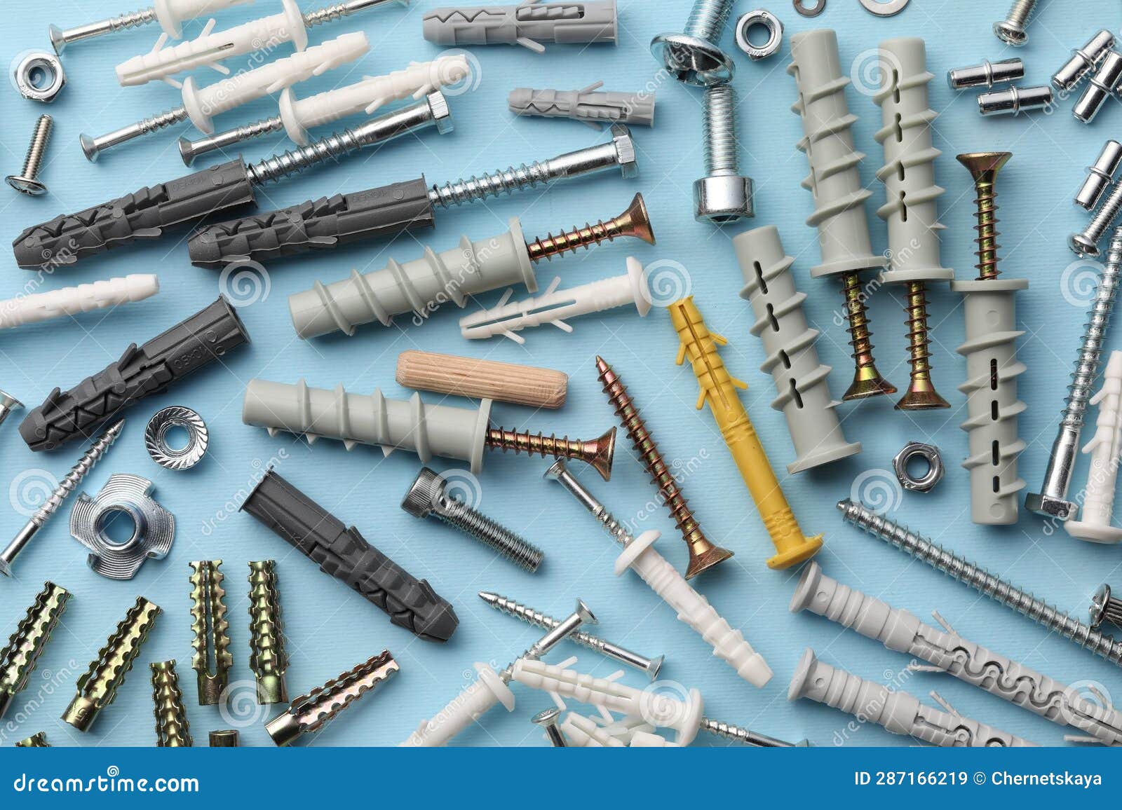 Many Different Fasteners and Dowels on Light Blue Background, Flat Lay ...
