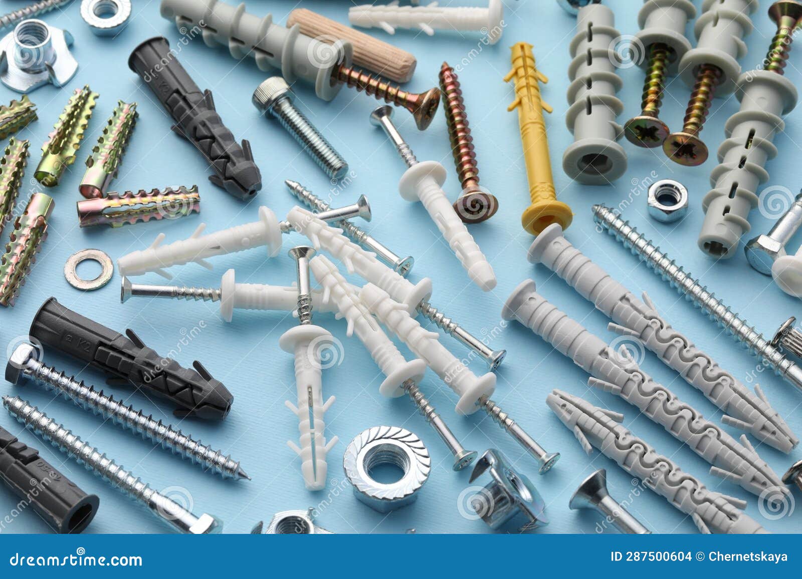 Many Different Fasteners and Dowels on Light Blue Background, Above ...