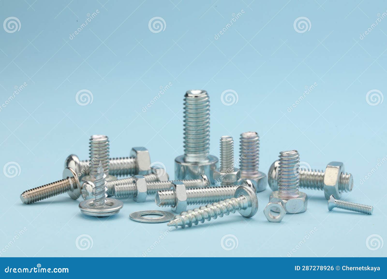 Many Different Fasteners on Light Blue Background, Closeup Stock Photo ...