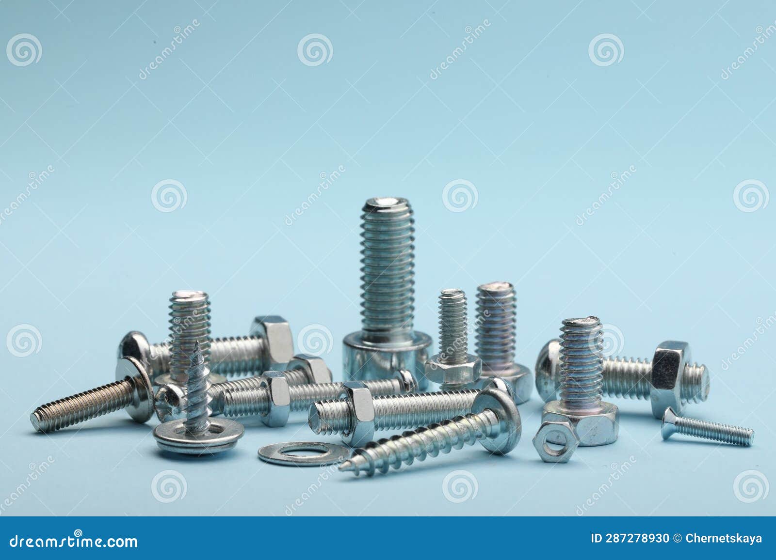 Many Different Fasteners on Light Blue Background, Closeup Stock Photo ...