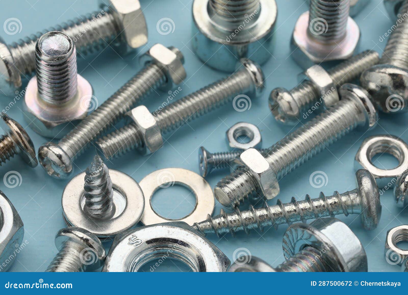 Many Different Fasteners on Light Blue Background, Closeup Stock Photo ...