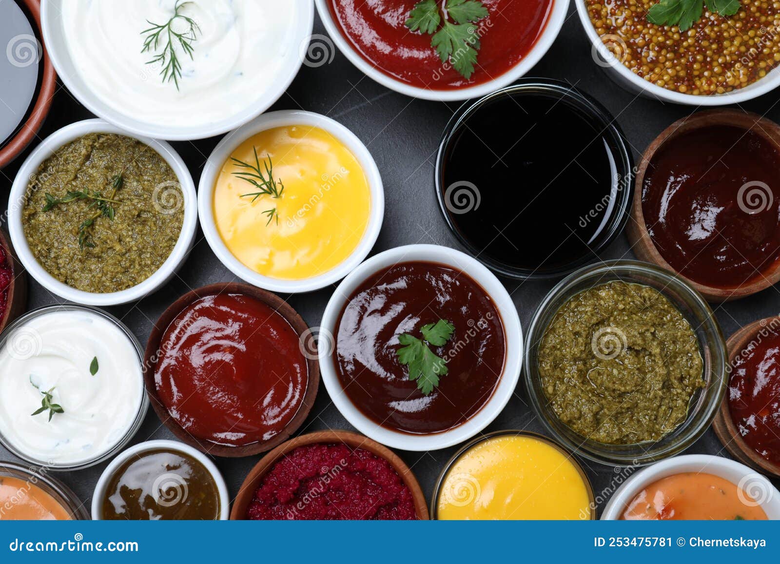 Many Different Sauces and Herbs on Black Table, Flat Lay Stock Image ...