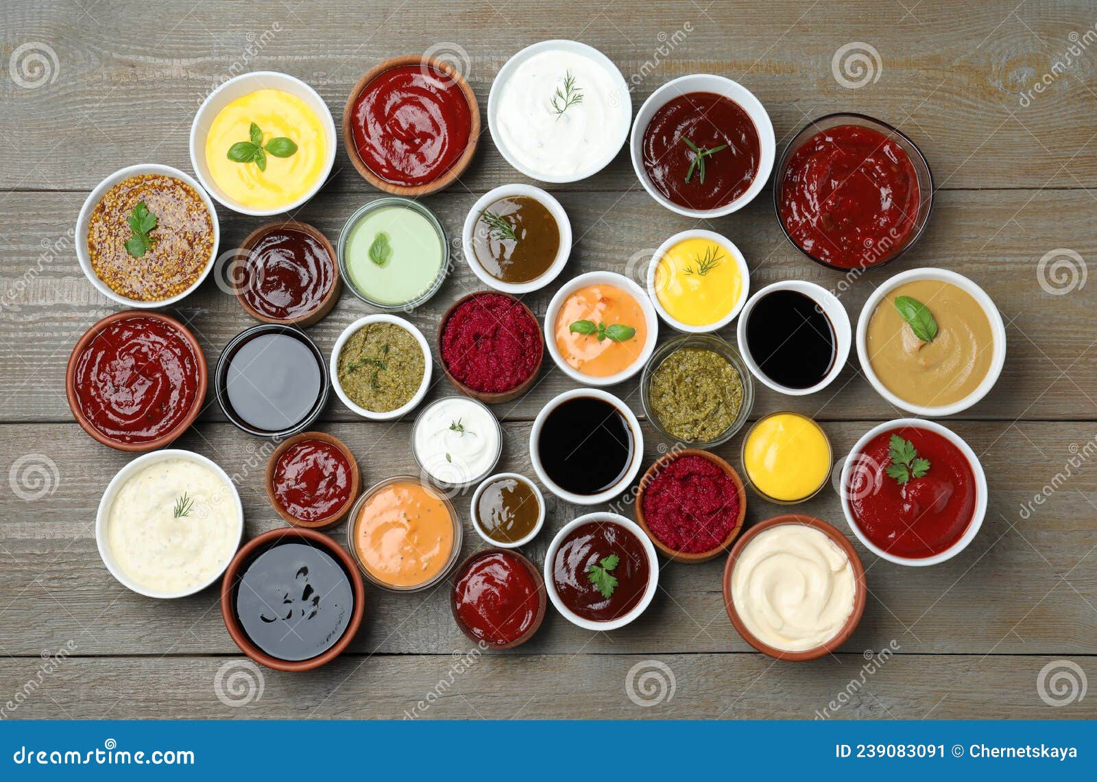 Many Different Sauces and Herbs on Wooden Table, Flat Lay Stock Image ...