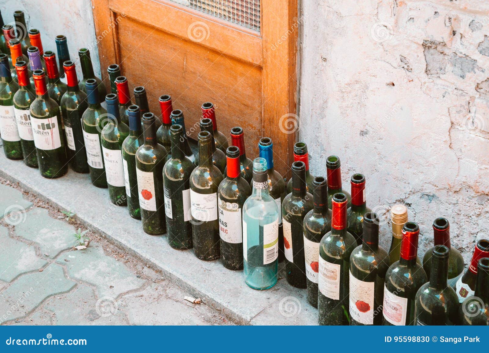 EMPTY WINE BOTTLES ARE PILLING UO AT GLASS WASTE CONTAINER Editorial ...