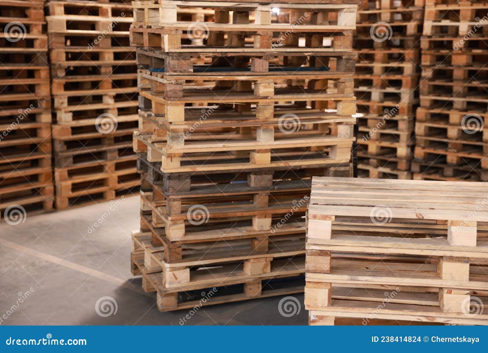 Many Empty Wooden Pallets Stacked in Warehouse Stock Photo - Image of ...