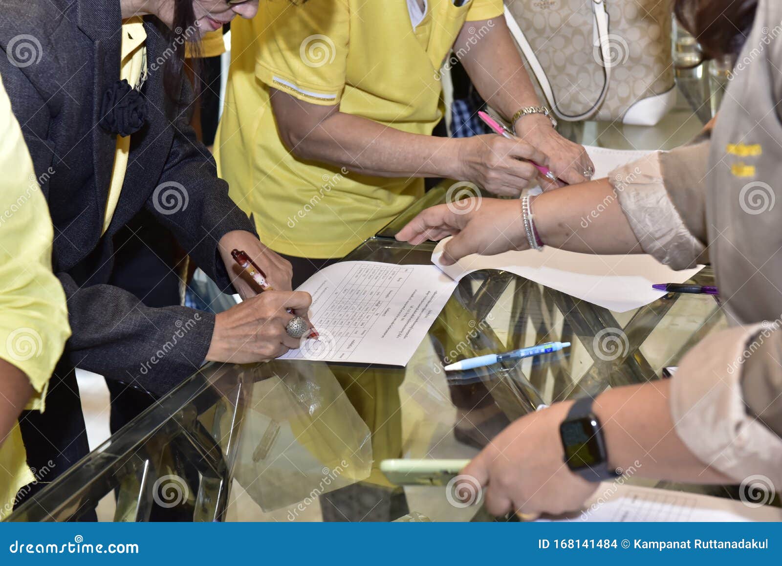 Many Hands are Signing Documents on the Table. Stock Photo - Image of ...