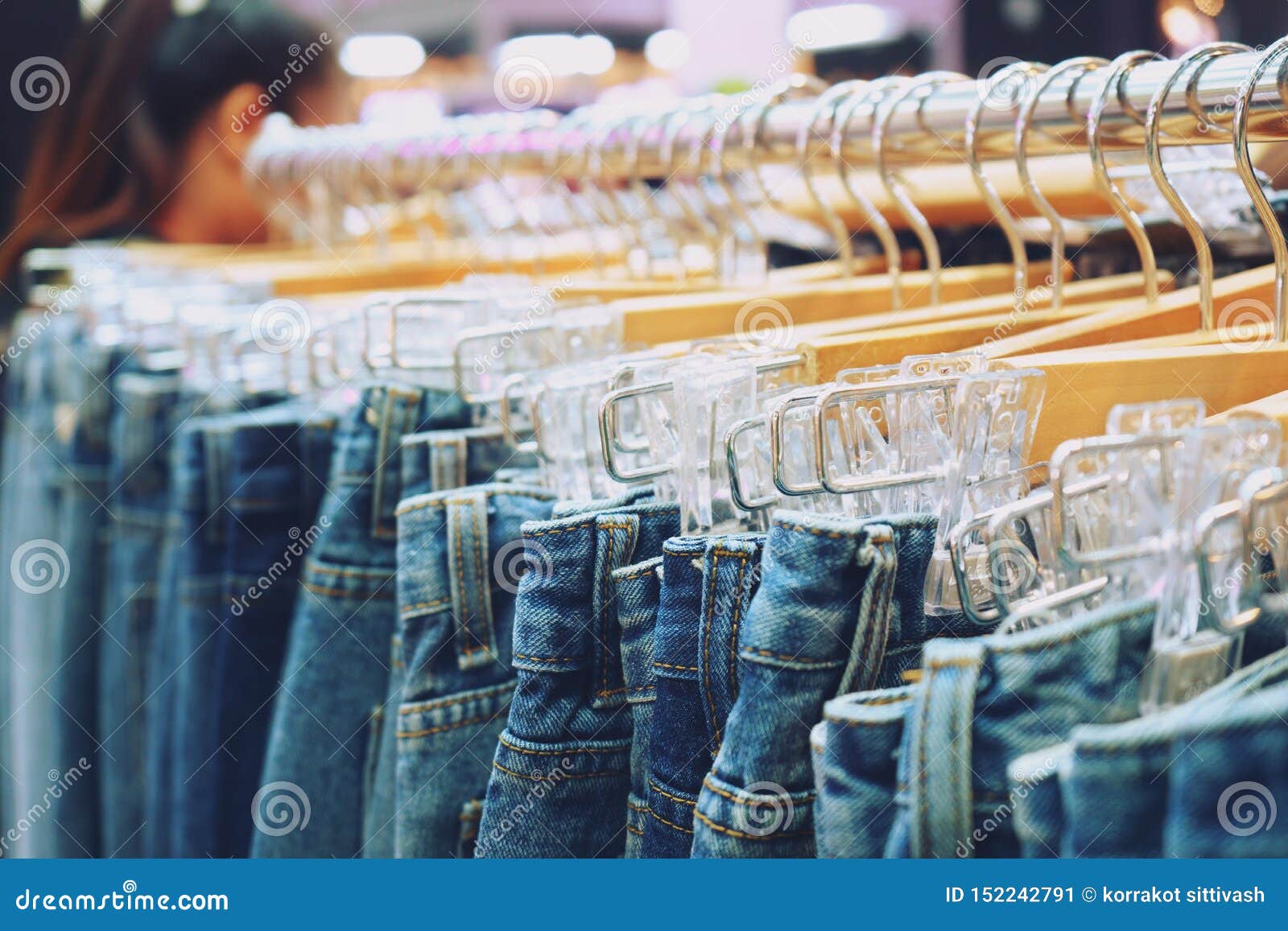 Many Jeans Hanging On A Rack. Row Of Pants Denim Jeans Hanging In ...