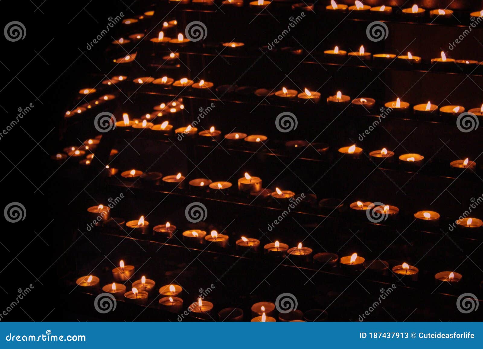 Many Lit Candles Stand in Rows Against a Dark Background Stock Image ...