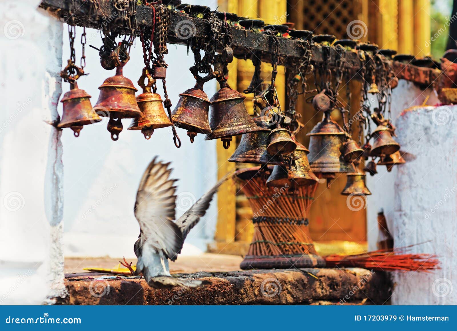 Many Metal Sacrificial Bells and Landing Dove Stock Image - Image of ...