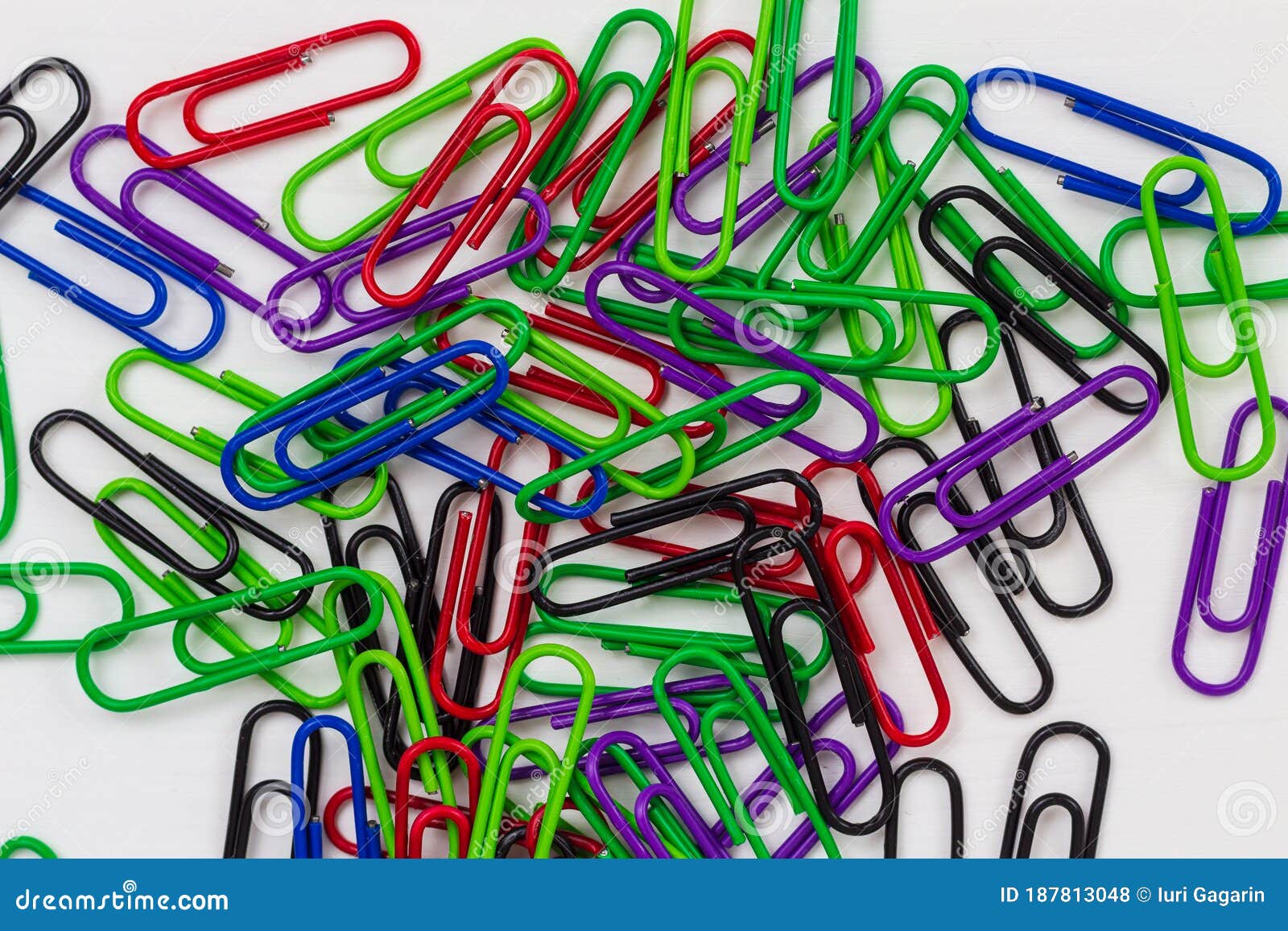 Many Multi-colored Paper Clips Lie on a White Wooden Table Stock Photo ...