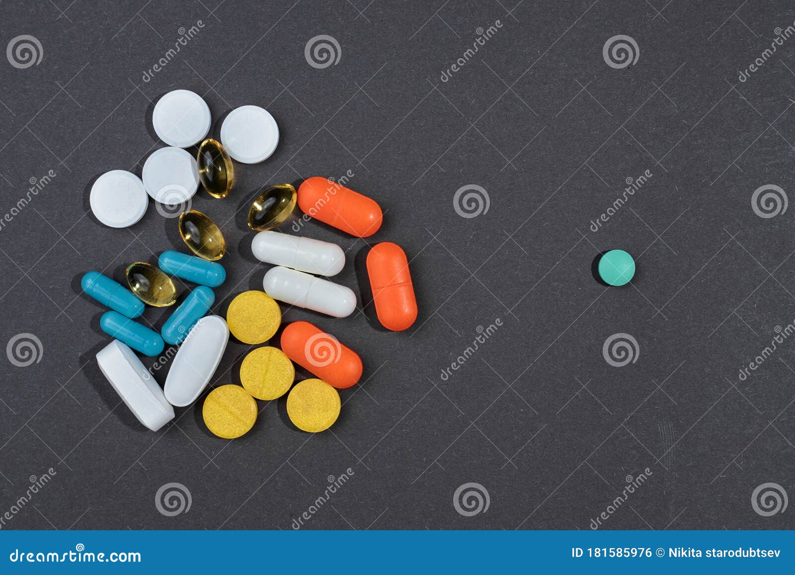 Many Multi-colored Tablets Against One on a Gray Background. View Top ...