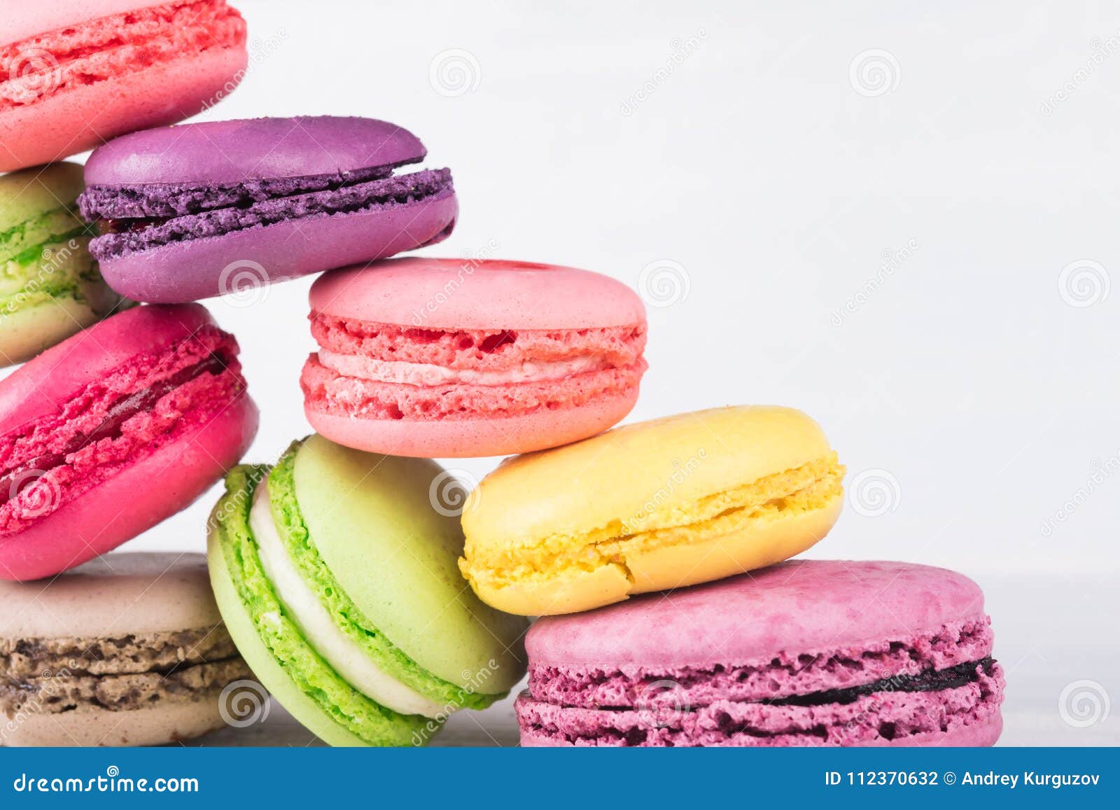 Many Multicolored Bright Biscuit Meringue Lie Pyramid in Left Corner on ...