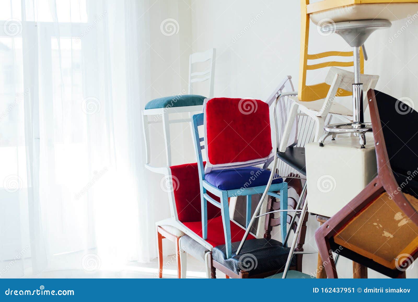 Many Multicolored Chairs in the Mess of the White Room Stock Image ...