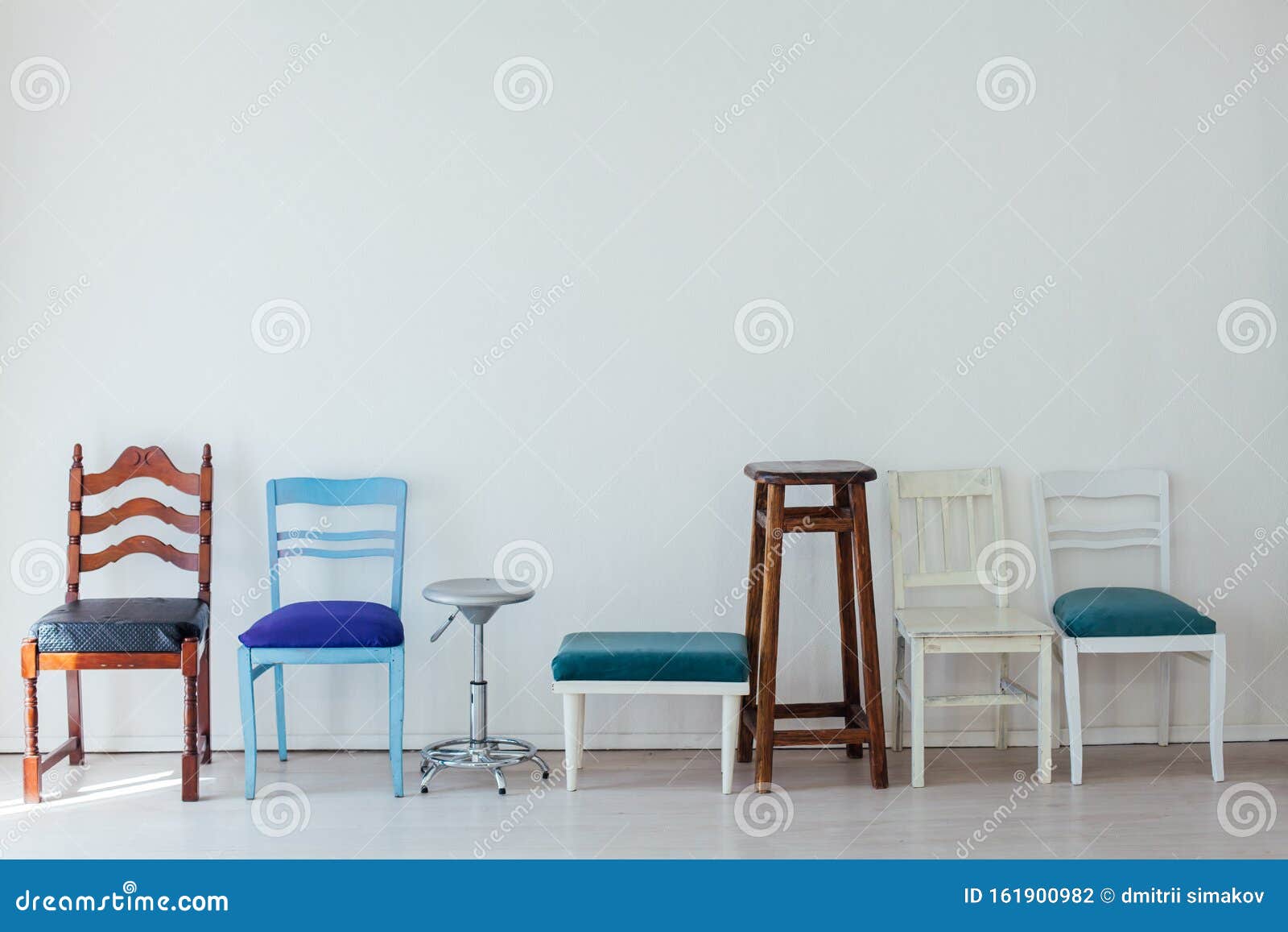 Many Multicolored Chairs in the Mess of the White Room Stock Photo ...