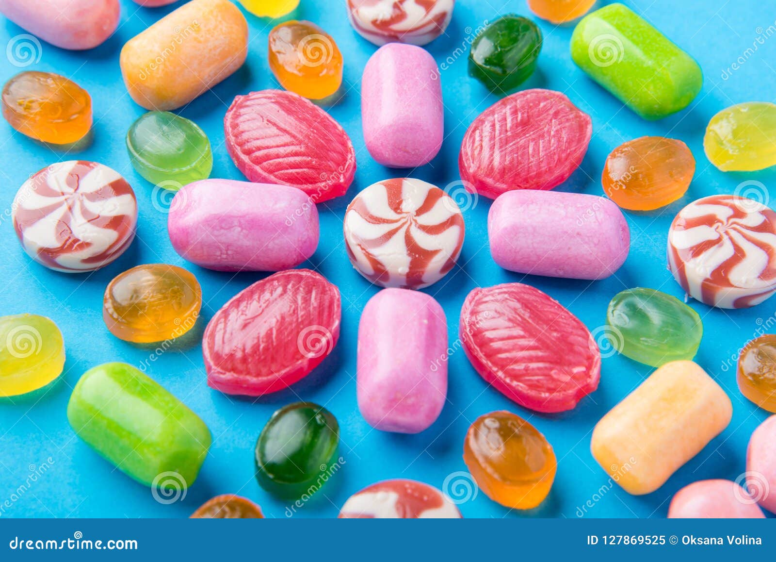 Many Multicolored Delicious Candies on a Blue Background Stock Image ...