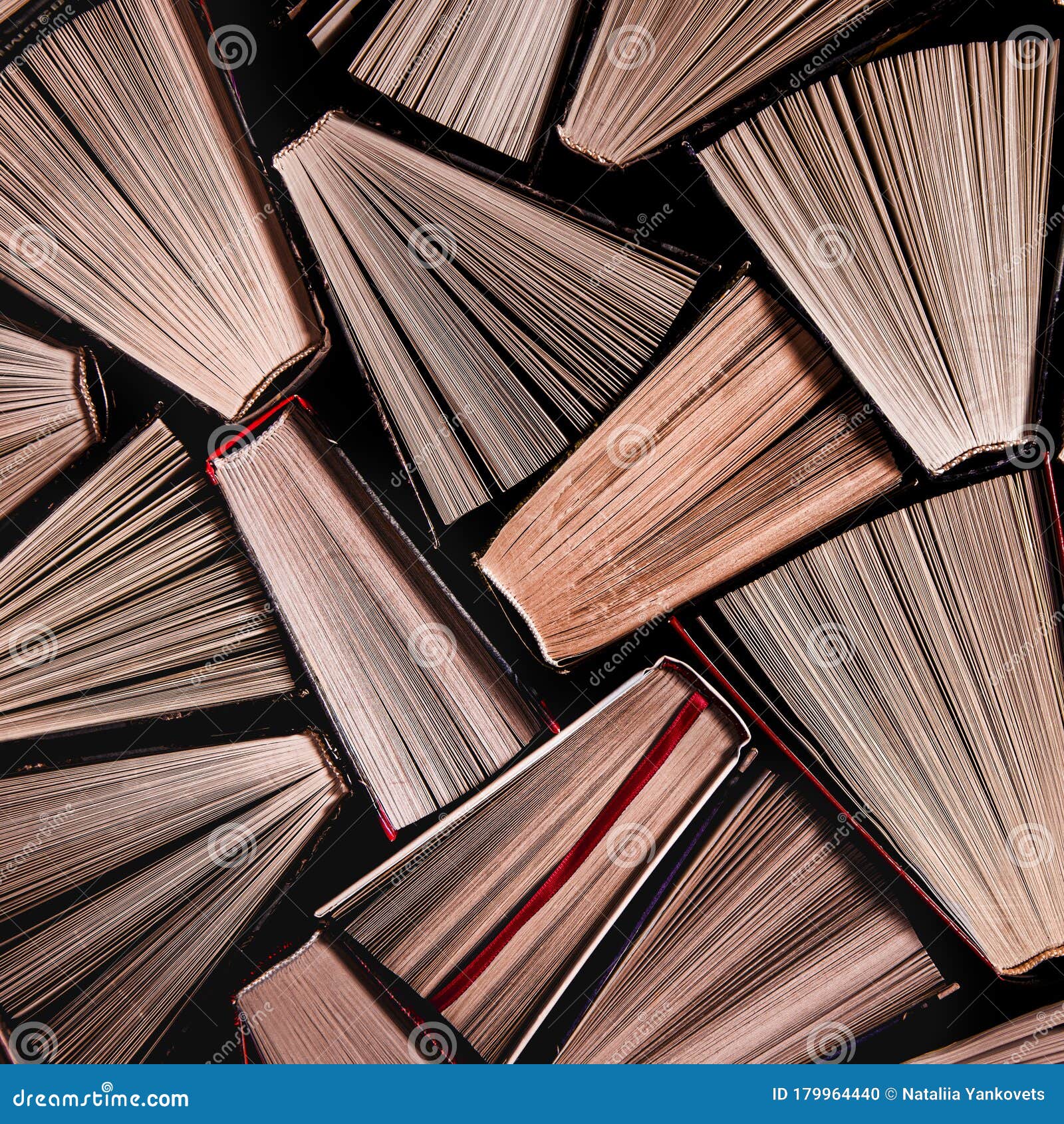 Many Old Multi-colored Open Books Stand on the Bookshelf in the Library ...