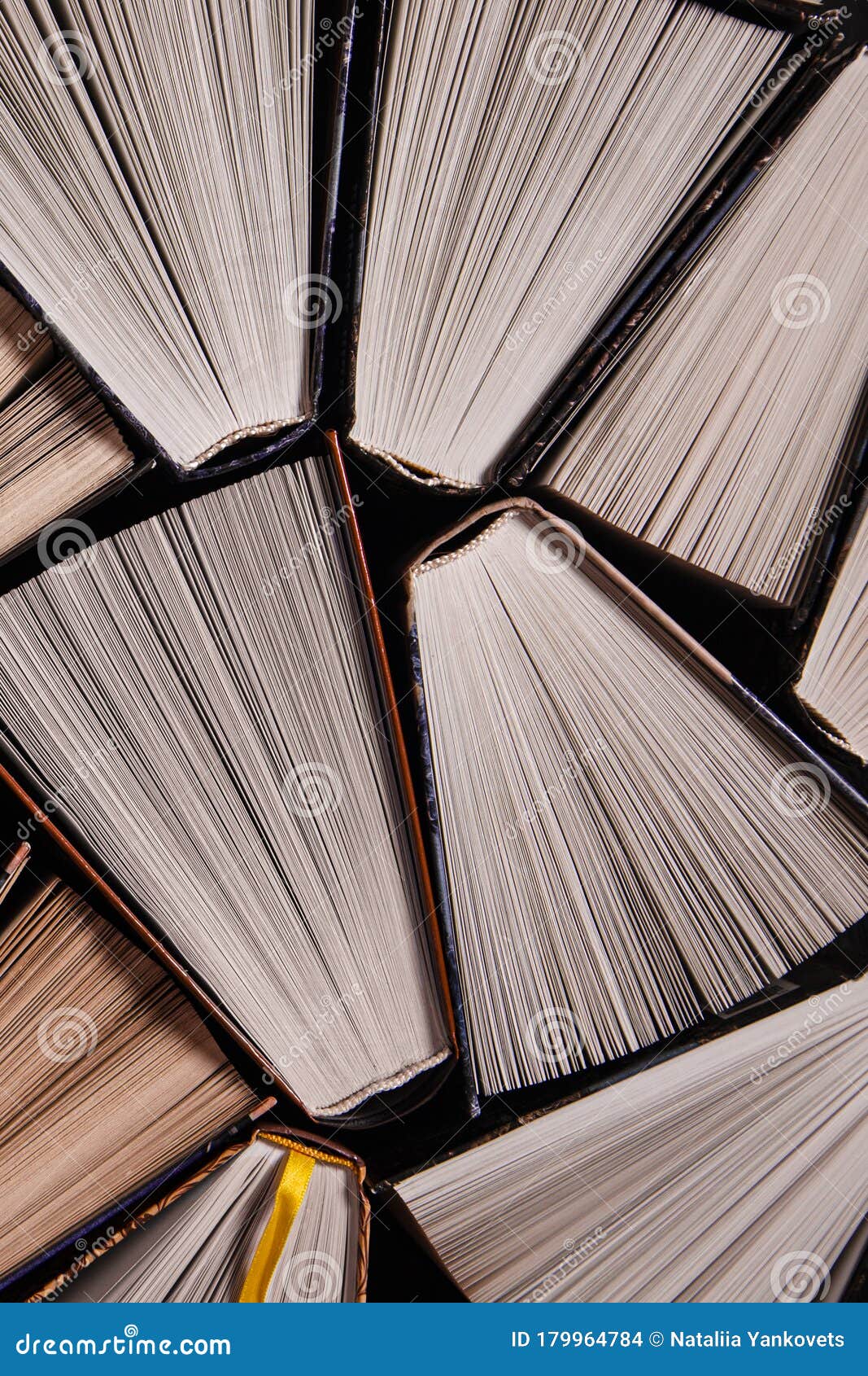 Many Old Multi-colored Open Books Stand on the Bookshelf in the Library ...