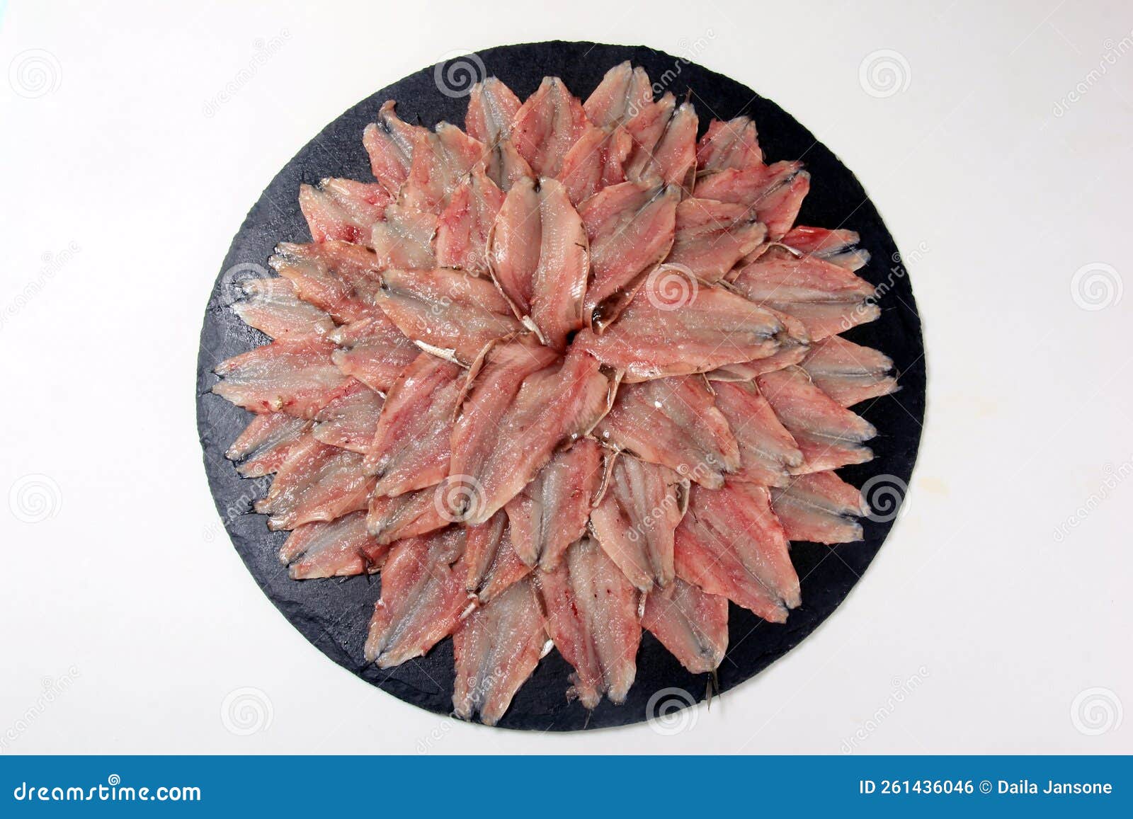 Many Opened and Cleaned Small Fish on a Plate on a White Background ...