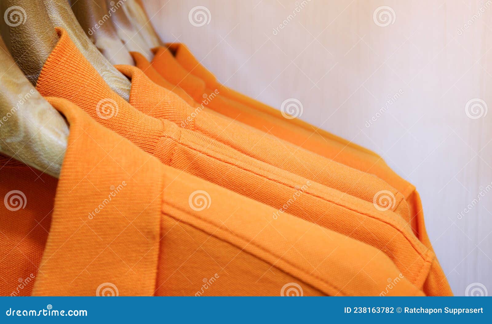 Many Orange Color Shirts Hanging on a Rack Stock Photo - Image of ...
