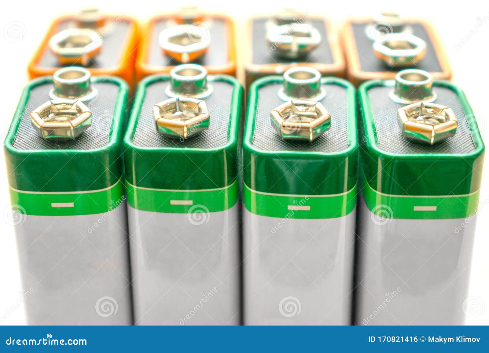 Many PP3 Batteries Stand in Several Rows. Four Green Batteries with ...