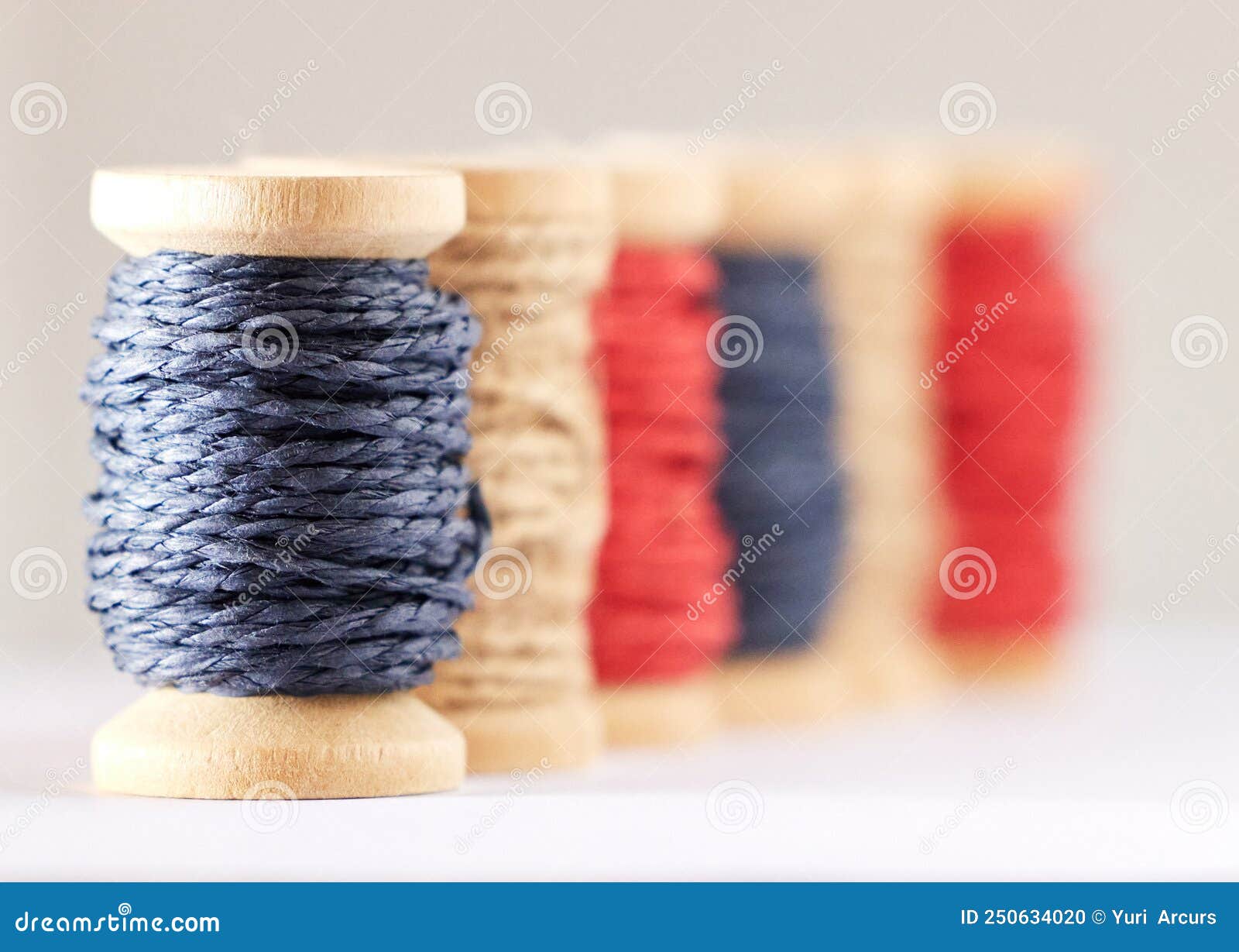 Many Rolls of Coloured Yarn or String Lined Up in a Row in Studio ...