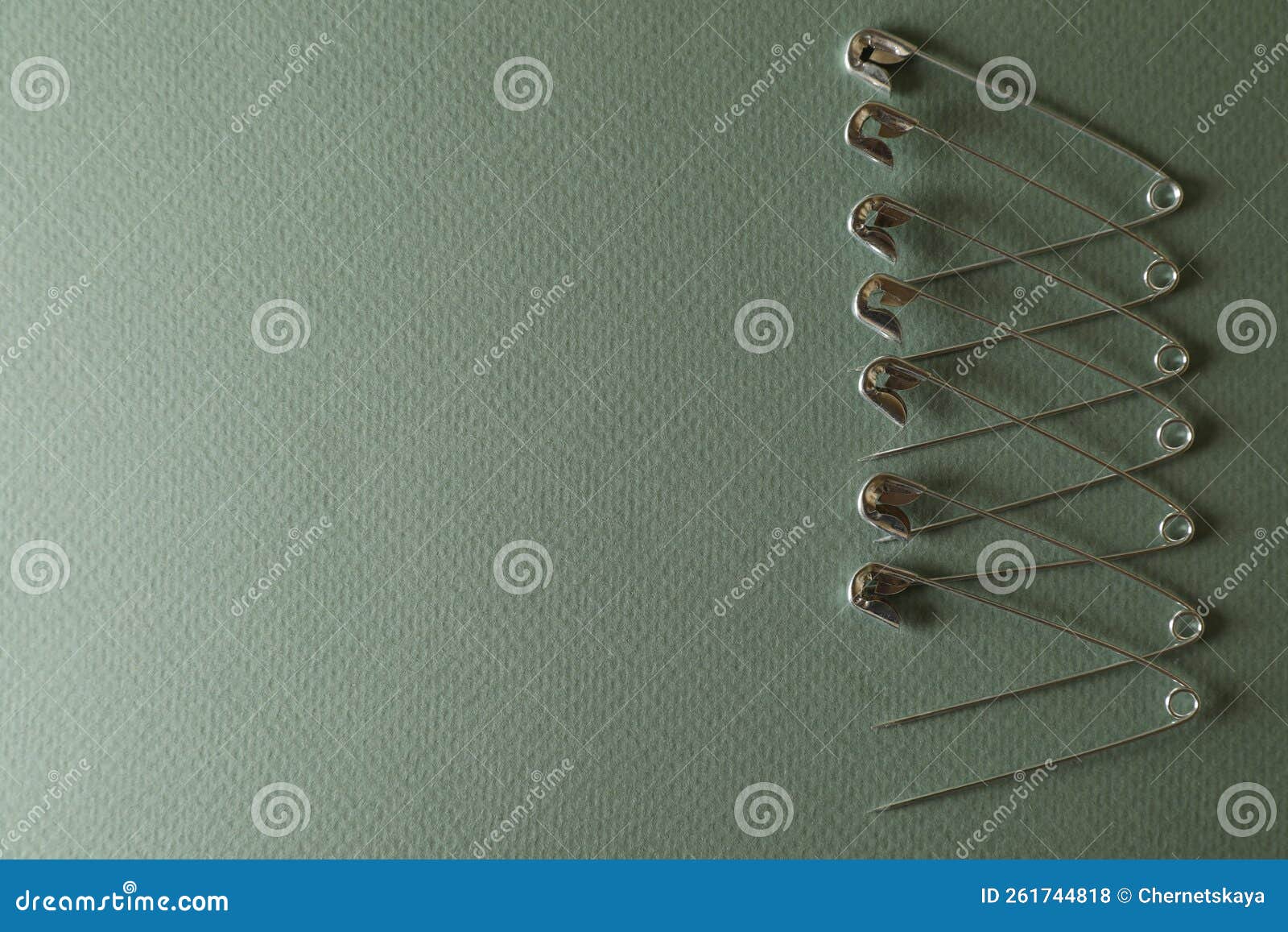 Many Safety Pins on Green Background, Flat Lay. Space for Text Stock ...