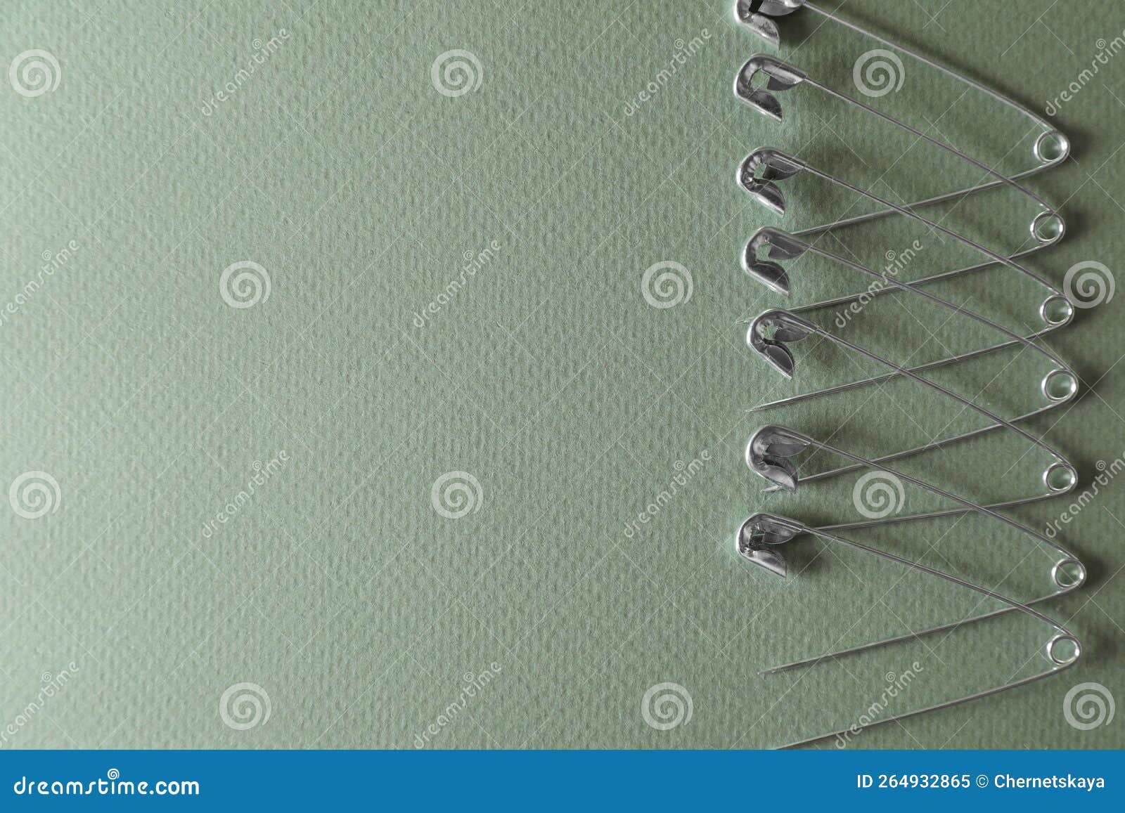 Many Safety Pins on Green Background, Flat Lay. Space for Text Stock ...