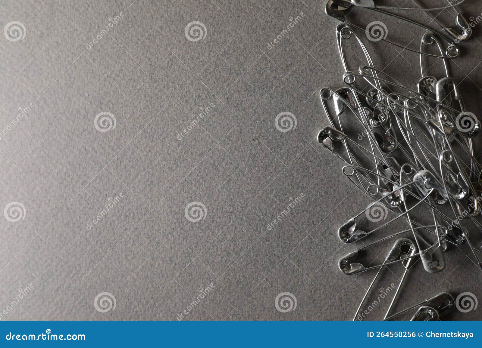 Many Safety Pins on Light Grey Textured Background, Flat Lay. Space for ...
