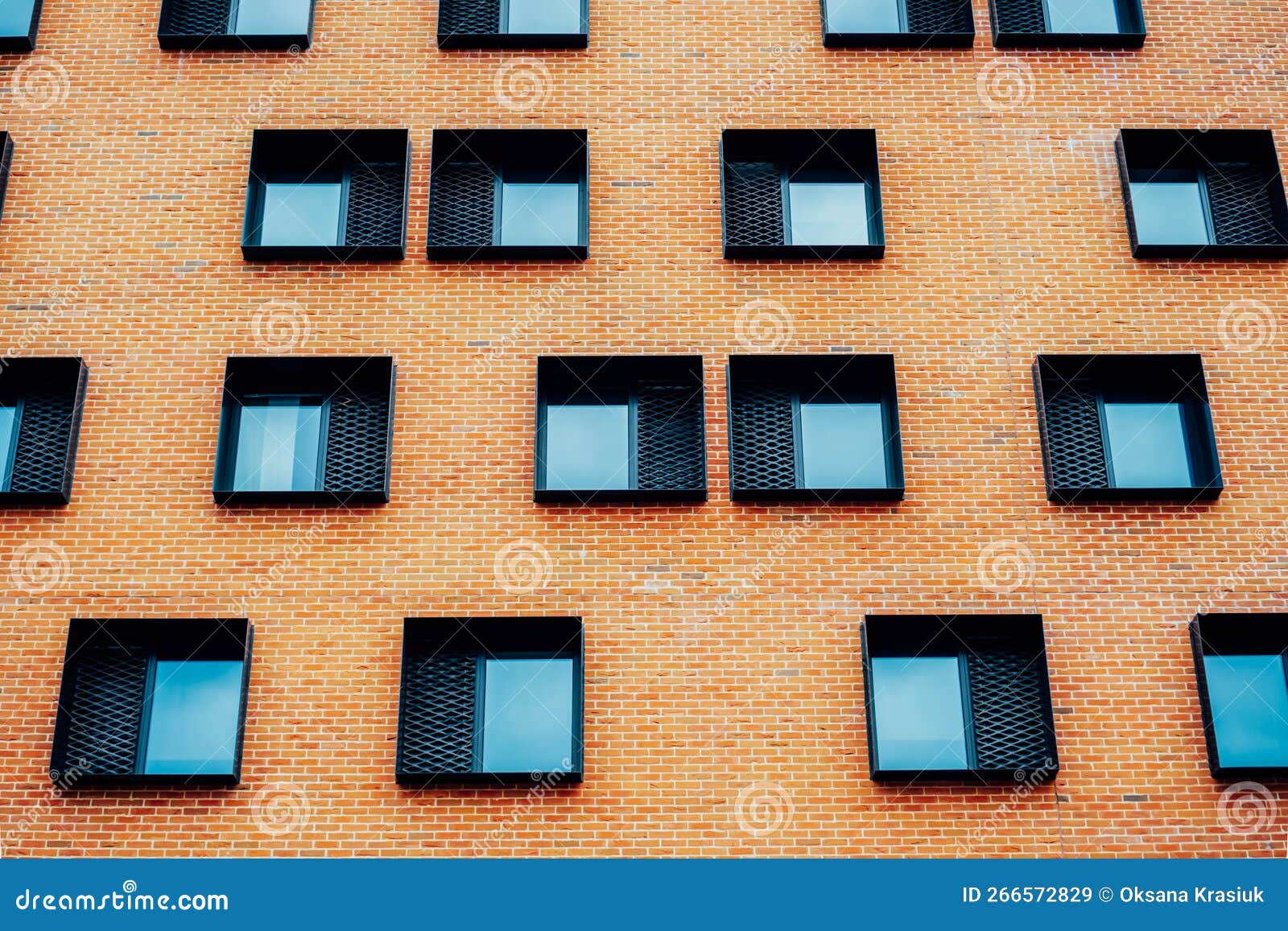 Many Same Quadratic Windows on a Modern Brown Brick Building in ...