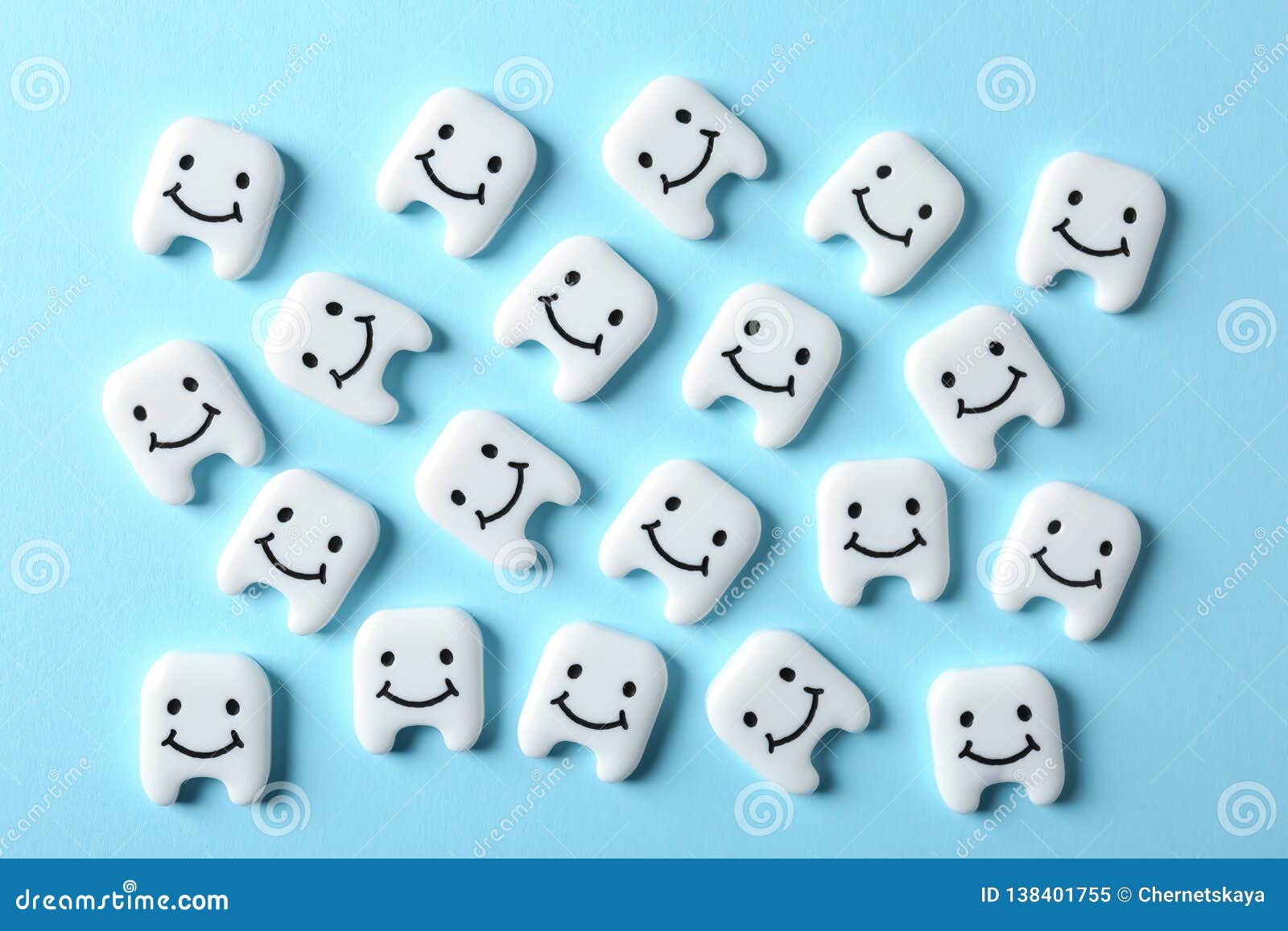 Many Small Plastic Teeth with Cute Faces on Color Background Stock ...
