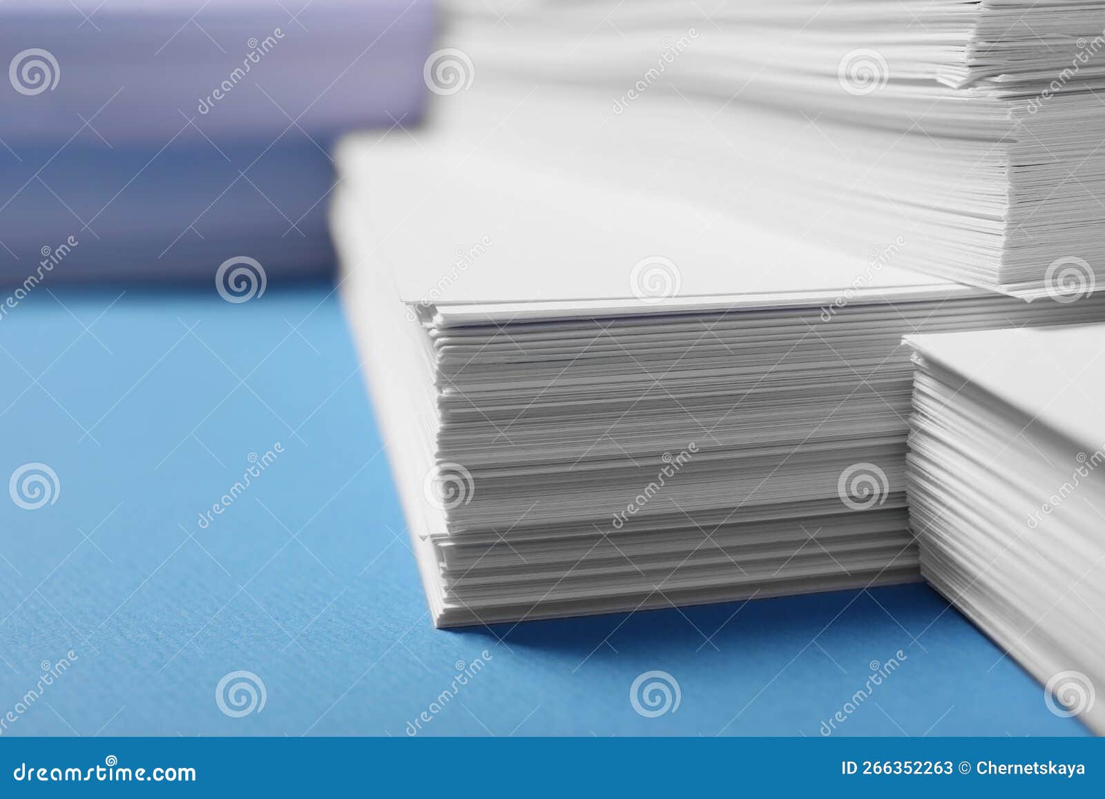 Many Stacks of Paper Sheets on Light Blue Background, Closeup Stock ...