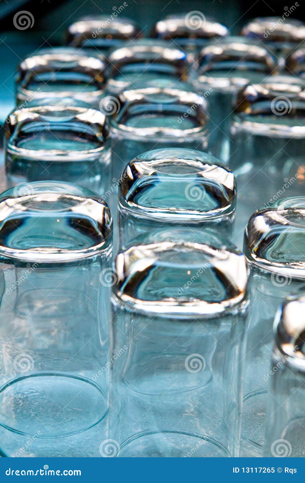 Many Transparent Glasses on Blue Background Stock Image - Image of ...