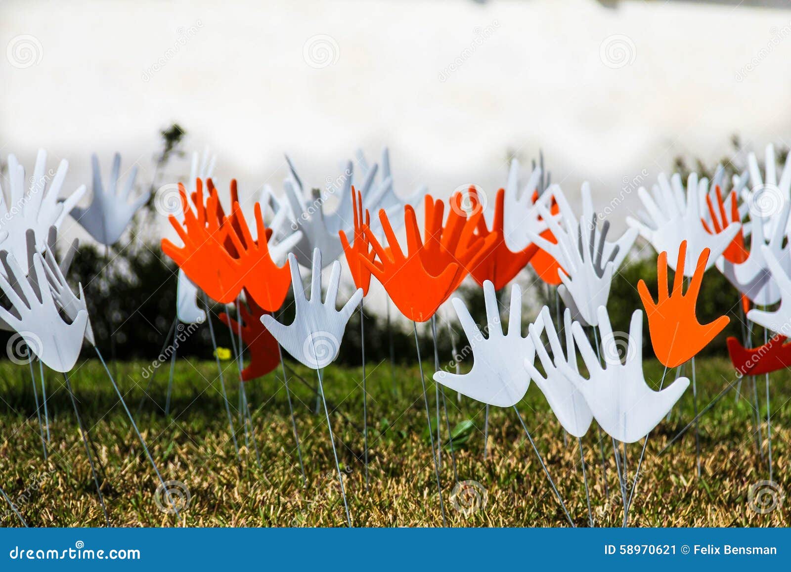 Many Waving Abstract Hands Signs or Flags Installed on a Grassy Lawn ...