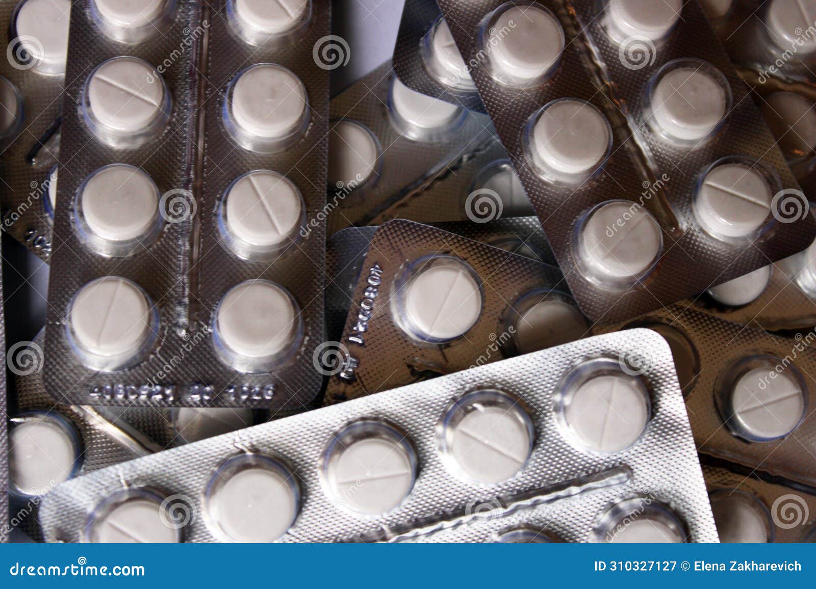 Many White Tablets in Silver Blisters are Scattered on a White ...