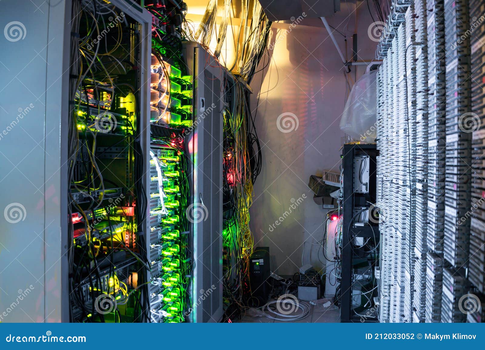 Many Wires And Computer Equipment Work In A Dark Server Room. The ...