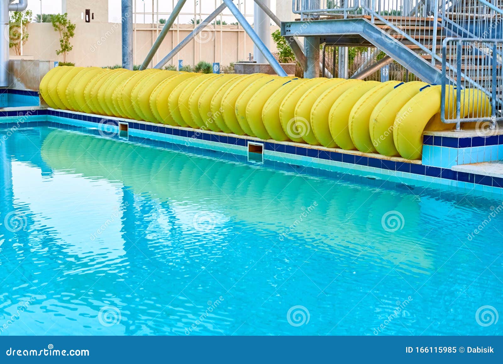 Many Yellow Inflatable Float in Blue Swimming Pool in the Water Park ...