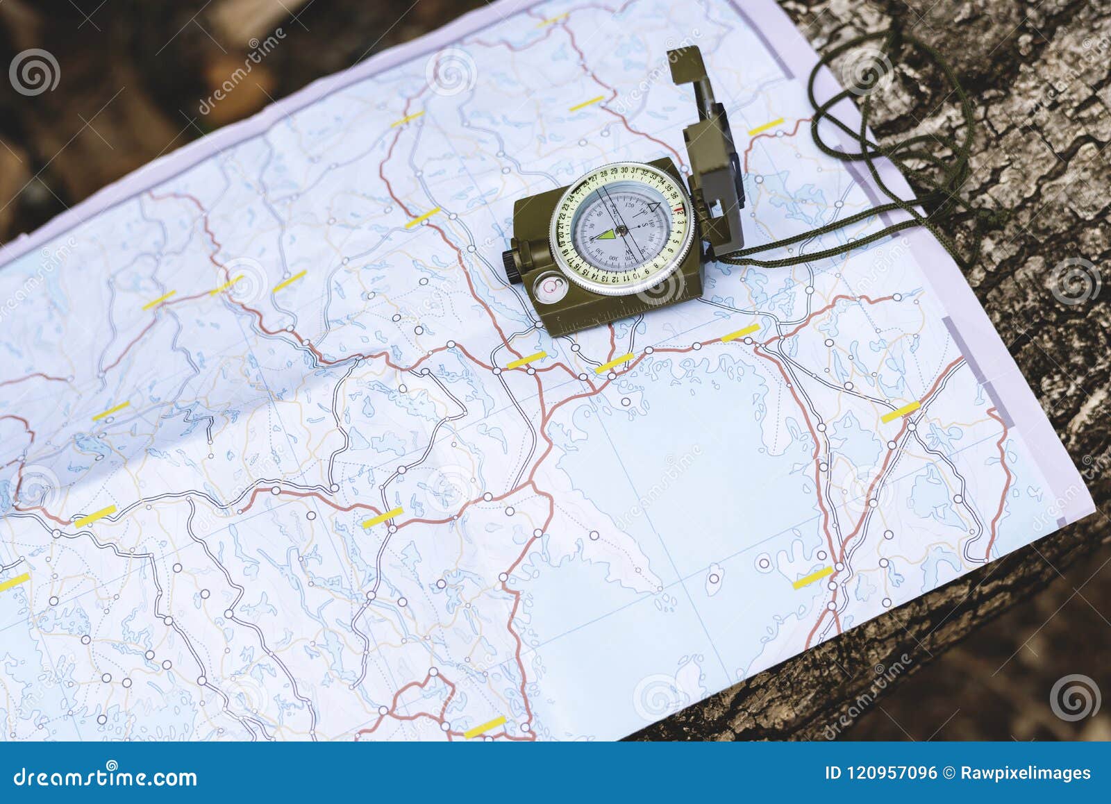 Map and Compass on Tree Trunk Stock Photo - Image of travel, outdoor ...