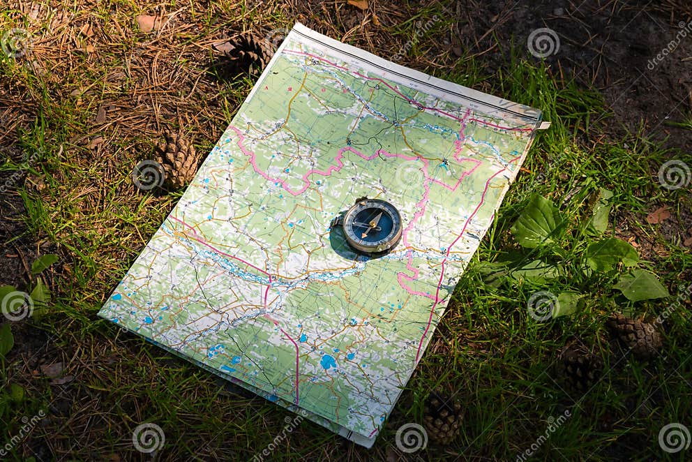 Map and Compass in the Woods Stock Photo - Image of forest, hand: 75373312