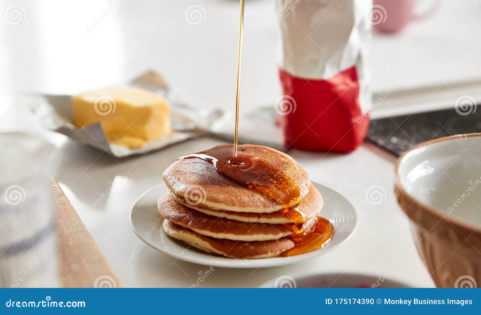 Maple Syrup Being Poured on Stack of Freshly Made Pancakes or Crepes on ...