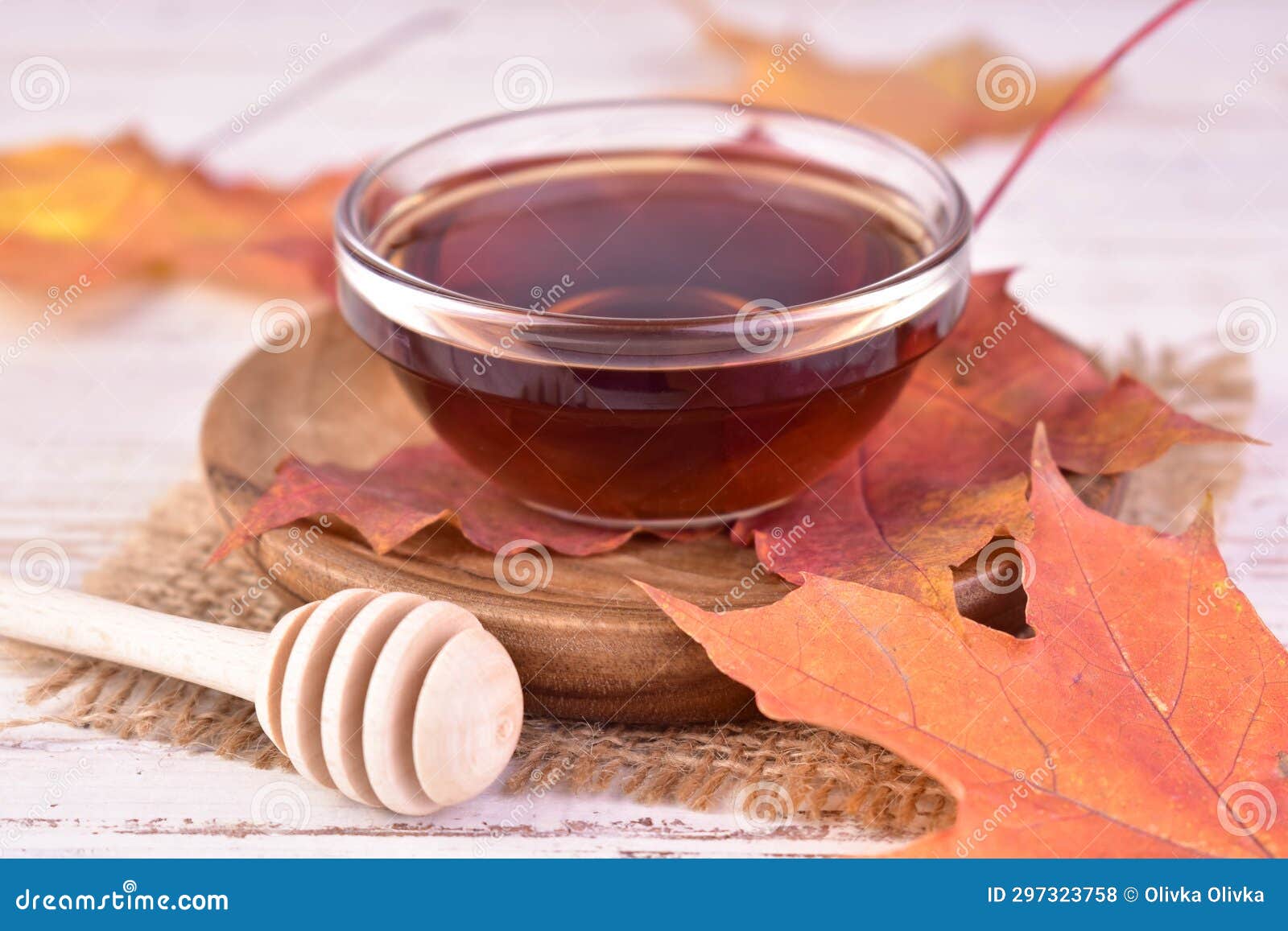 Maple Syrup in a Bowl on a Background of Maple Leaves.Close-up. Stock ...